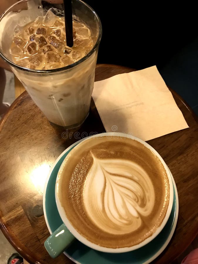 Milk Coffee with Ice Cubes on the Table and Coffee Milk in Cups on the ...