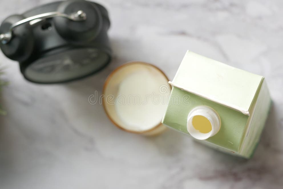 Milk Container , Glass of Milk and Clock on Table Stock Image - Image ...