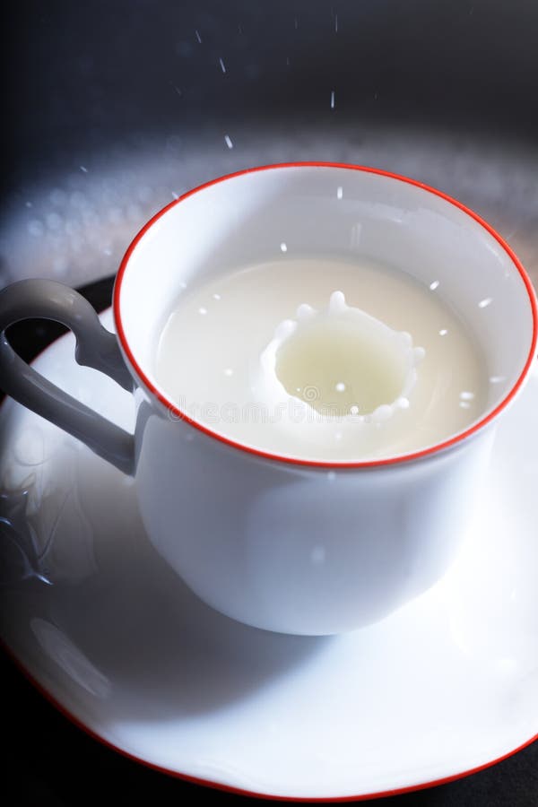 Milk Drops Drip into a Cup with Organic Milk Making Splash Around a ...