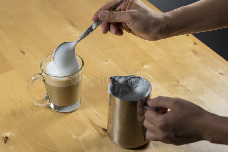 Milk Filling on Top of Hot Cappuccino Coffee. Stock Photo - Image of ...