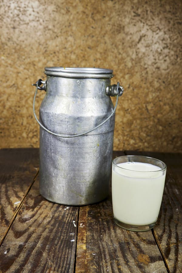 Milk in Glass Cup and Aluminium Can on Wood Table Stock Photo - Image ...