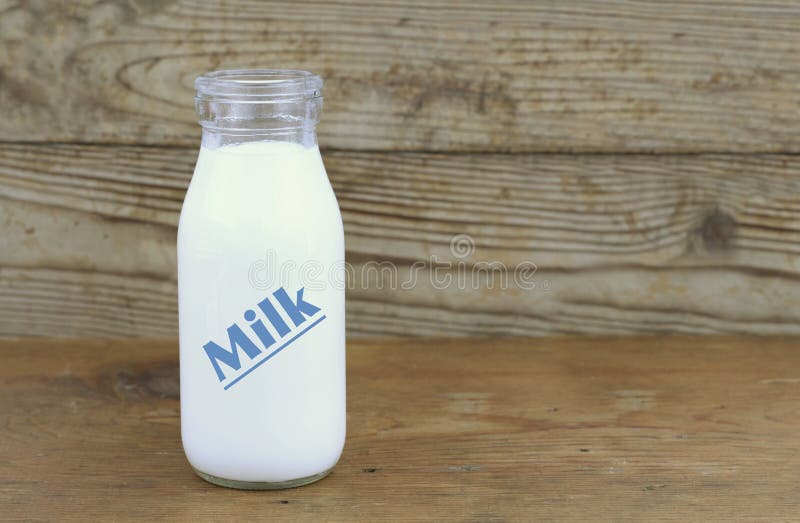 Milk and Old Style Bottle on Wood Table Stock Image - Image of ...