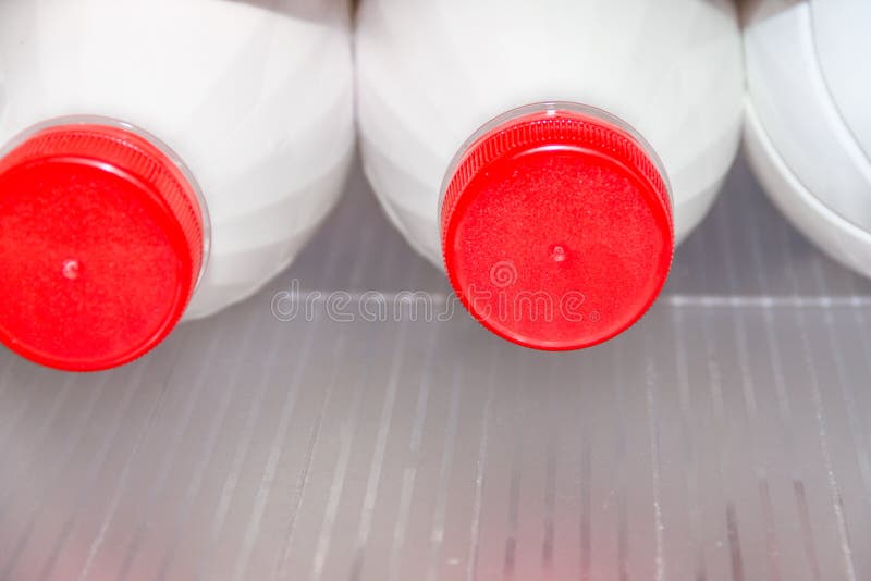 Milk in Plastic Bottles is on the Shelf in the Refrigerator Stock Photo ...