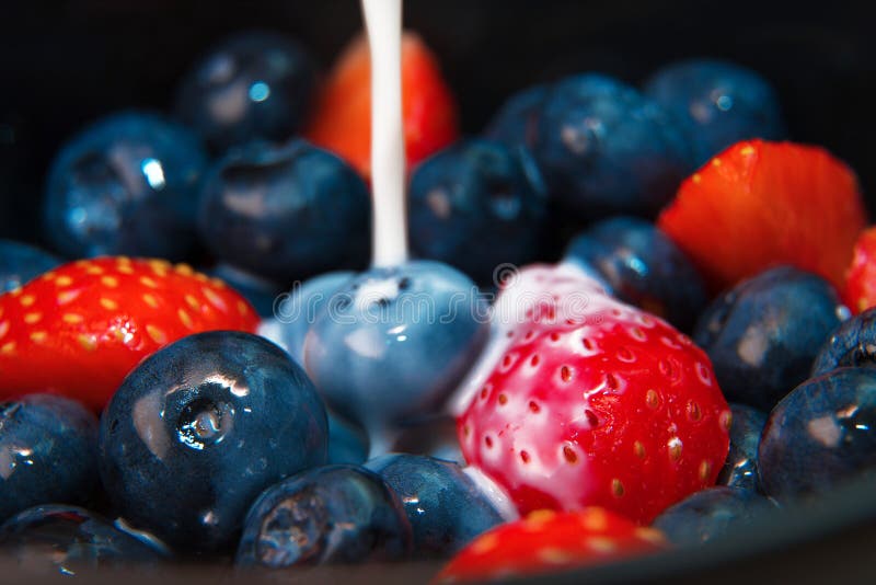 Milk Pouring on Blueberries and Strawberries. Stock Image - Image of ...