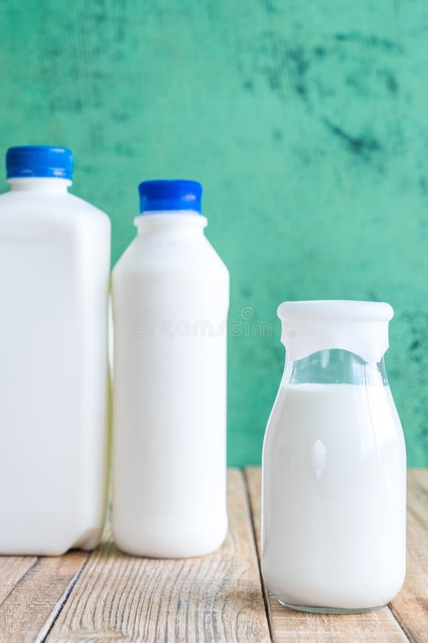 Milk on a Wooden Table on Green Background Stock Photo - Image of white ...