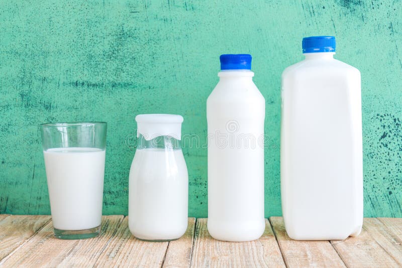Milk on a Wooden Table on Green Background Stock Image - Image of ...