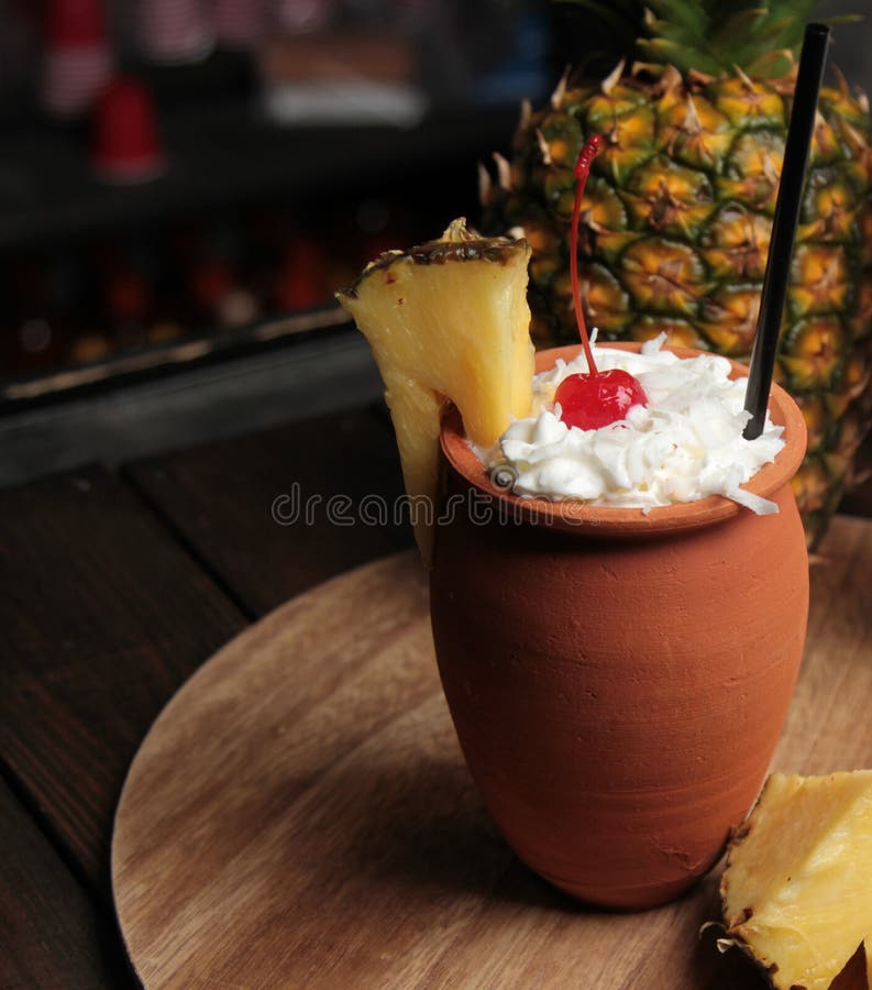 Milkshake in a Clay Jar with Pineapple and Cherry Garnish Stock Photo ...