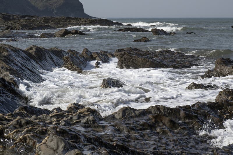 Milky White Surf Hitting the Rocks Stock Image - Image of rock, rocky ...