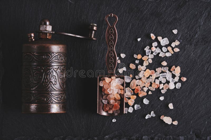 A Mill and a Spice Spoon with Loose Pink Salt on Slate. Stock Image ...