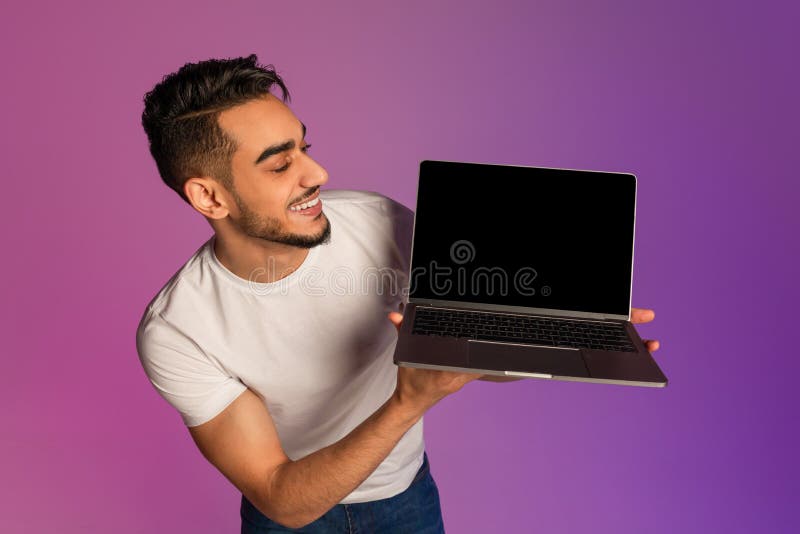 Millennial Arab Man Showing Laptop Computer with Empty Black Screen in ...