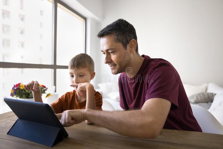 Millennial Dad Help School Age Son with Elearning Using Tablet Stock Image - Image of distant ...
