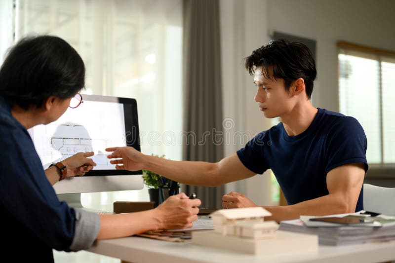 Millennial Male Client Discussing Building Design Project with ...