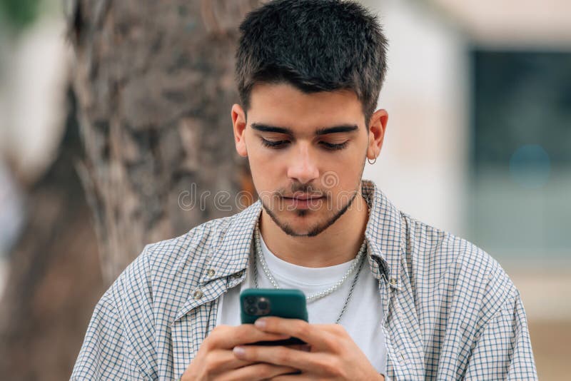 Millennial Student Looking at Mobile Phone on the Street Stock Photo ...
