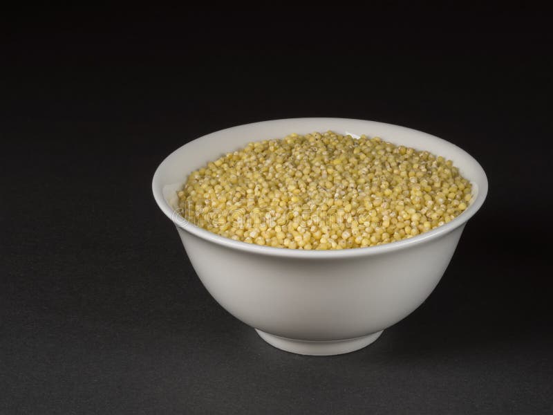 Millet in a Bowl Closeup on Dark Background. Stock Image - Image of ...