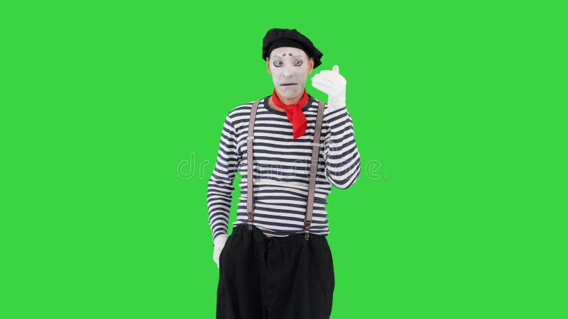 Mime Talking on Imaginary Phone on a Green Screen, Chroma Key. Stock ...