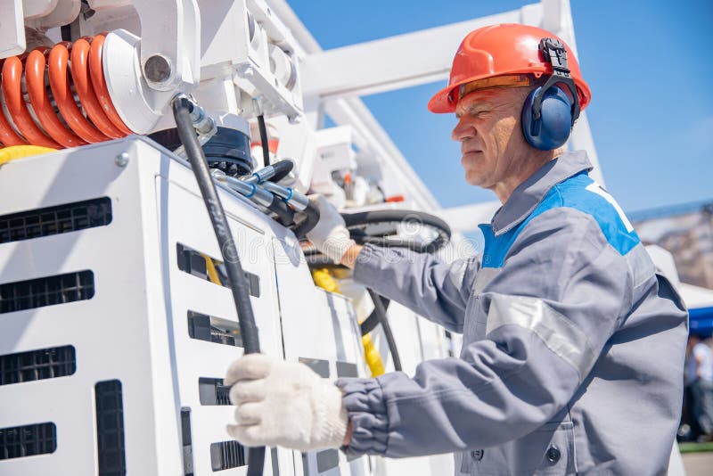 Miner Operator in Helmet Control Drilling Machine in Coal Mine. Concept ...