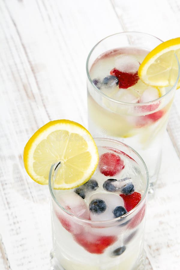 Mineral Water with Fruit Frozen in Ice Cubes Stock Image - Image of ...