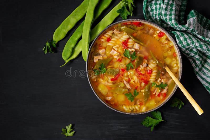 Minestrone, Italian Vegetable Soup with Pasta on Black Table. Top View ...