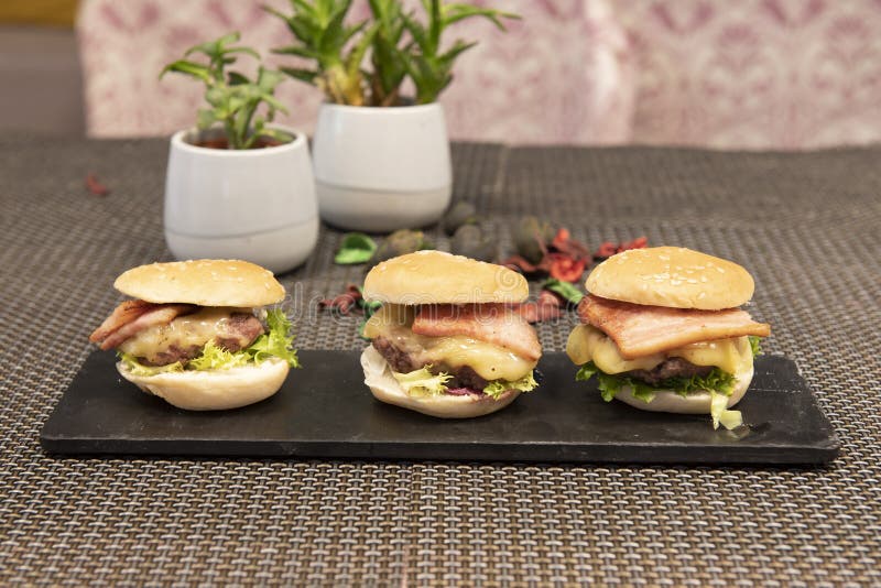 Mini Beef Burgers with Melted Cheese and Fried Bacon Stock Image ...