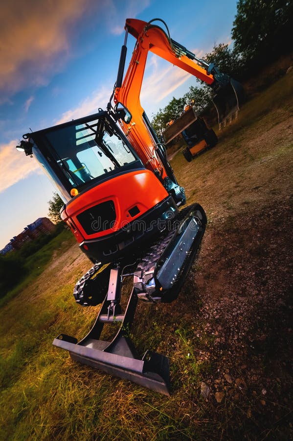 Mini Bulldozer, Small Excavator Against the Backdrop of the Sunset Sky ...