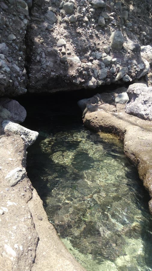 Mini cave in the seashore stock photo. Image of seashore - 76356446