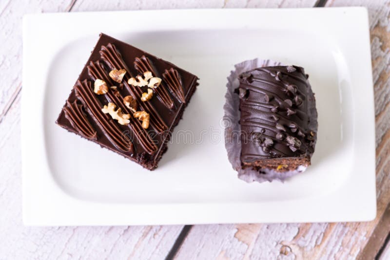 A Mini Chocolate Cake Roll and a Square Slice of Chocolate Cake on ...