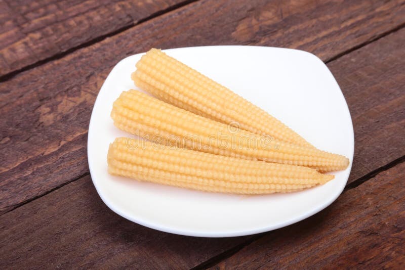 Mini Corn Cob Preserved on Plate on Wooden Board. Stock Photo - Image ...