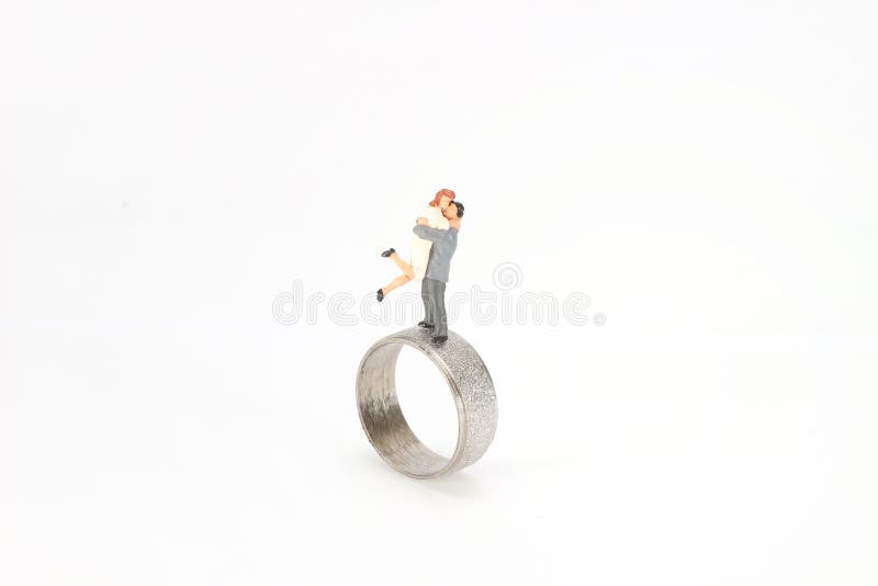 A Mini Couple is Hugging with a Ring Stock Photo - Image of investment ...
