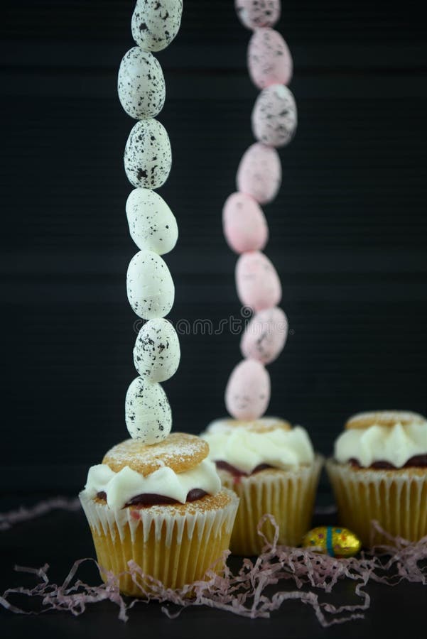 Mini Cream Cakes with Easter Eggs in a Tall Vertical Line for Creative ...