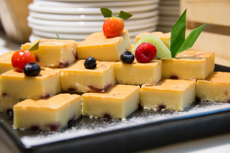 Mini Cut Butter Cake on Black Plate Stock Photo - Image of yummy ...