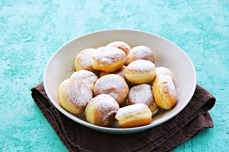 Mini Donuts Made from Yeast Dough Sprinkled with Icing Sugar in a Gray ...