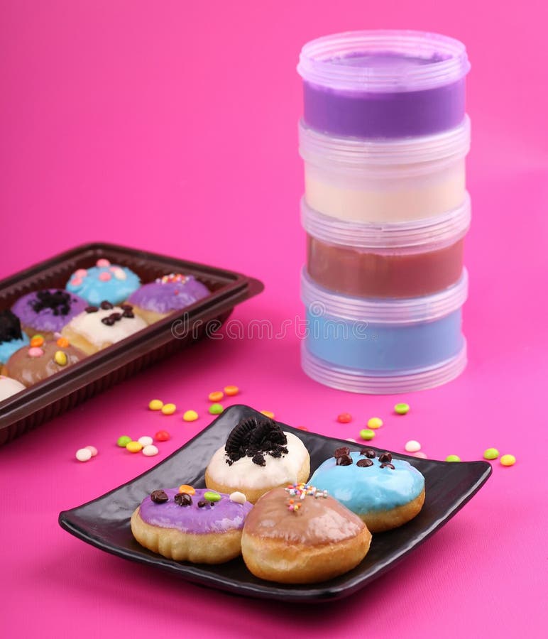 Mini Donuts with Variant Topping on Black Plate Stock Photo - Image of ...