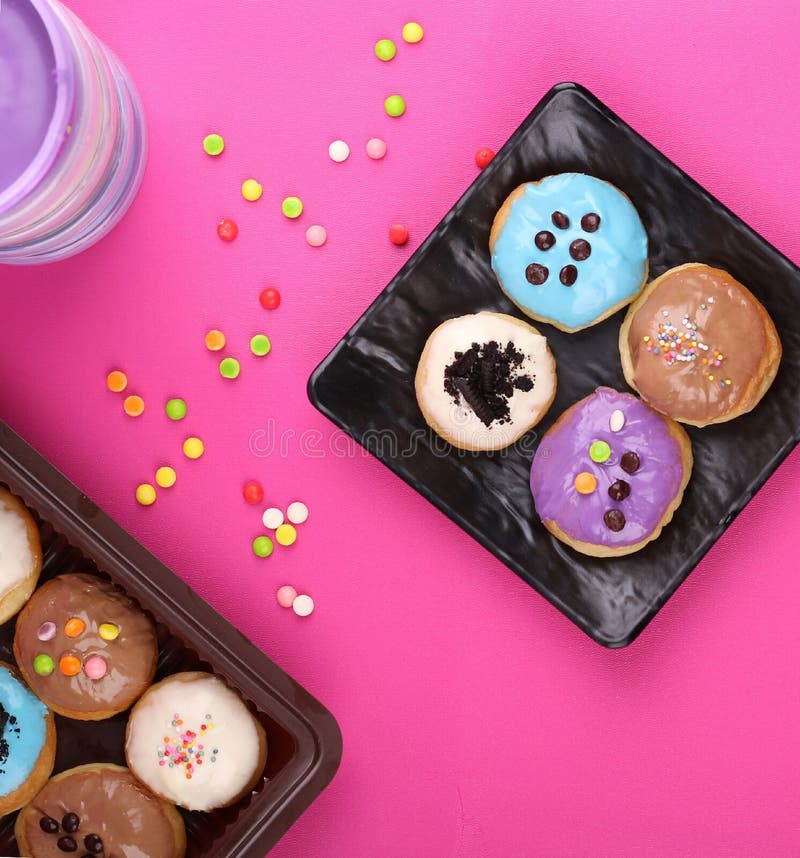Mini Donuts with Variant Topping on Pink Table Stock Photo - Image of ...