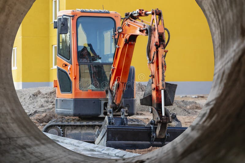 Mini Excavator at the Construction Site. Compact Construction Equipment ...