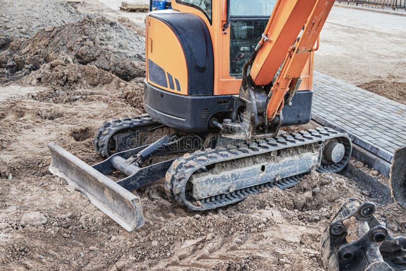 Mini Excavator at the Construction Site. Compact Construction Equipment ...