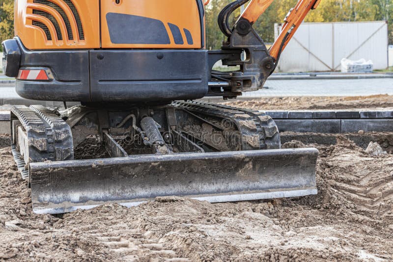 Mini Excavator at the Construction Site. Compact Construction Equipment ...
