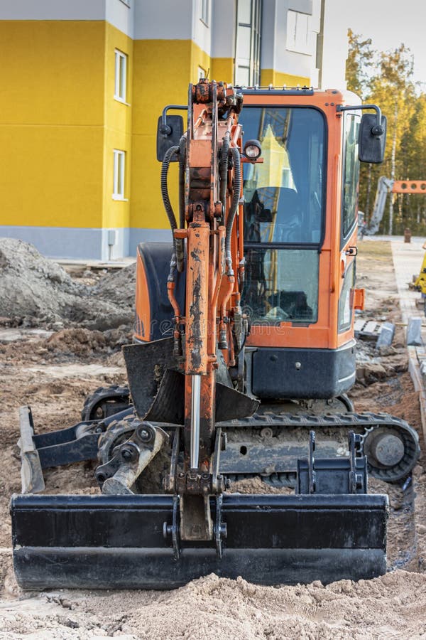 Mini Excavator at the Construction Site. Compact Construction Equipment ...