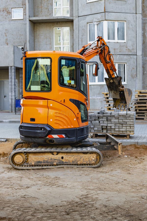 Mini Excavator at the Construction Site. Compact Construction Equipment ...