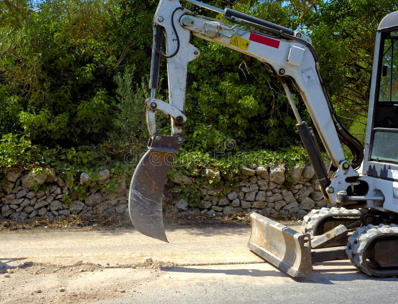 Mini Excavator Digging Up a Electrical Cables from Trench Stock Photo ...