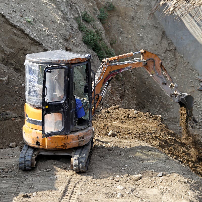 Mini Excavator Digging Up a Electrical Cables from Trench 3 Stock Photo ...