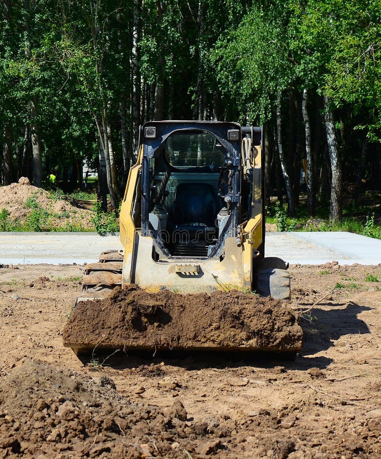 Mini Excavator Digging and Pushing Ground in Construction Site. Stock ...