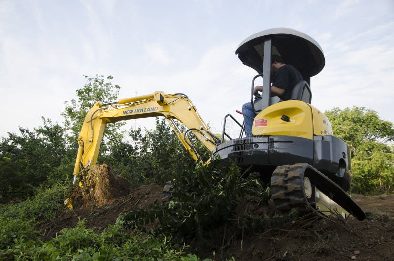 Mini Excavator Digging Up a Electrical Cables from Trench Stock Photo ...