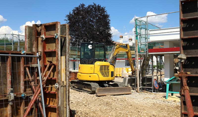 Mini Excavator at Work in a New Development Area, among Eco Friendly ...