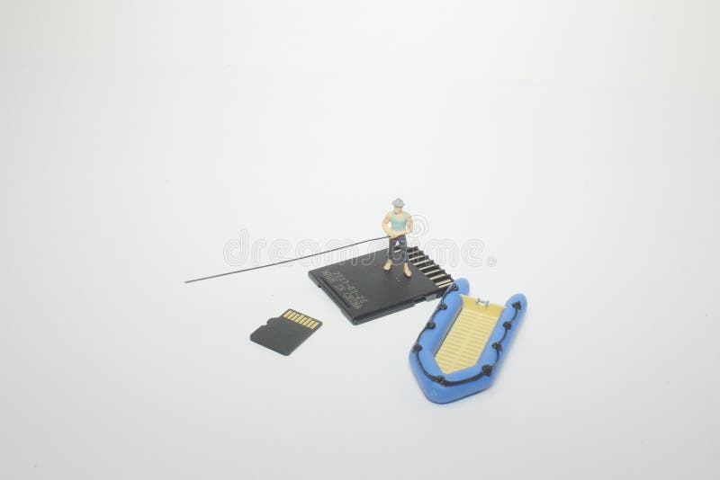 Mini Figure of Fish Man Stand on Sd Card Stock Photo - Image of system ...