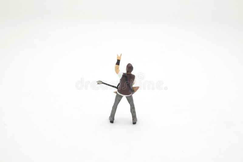 A Mini Figure Man Playing Guitar on Board Stock Photo - Image of guitar ...