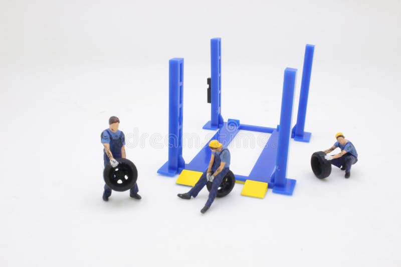 A Mini Figure Mechanics Working on Car Engine Stock Image - Image of ...