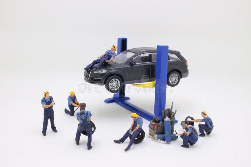 A Mini Figure Mechanics Working on Car Engine Stock Photo - Image of ...