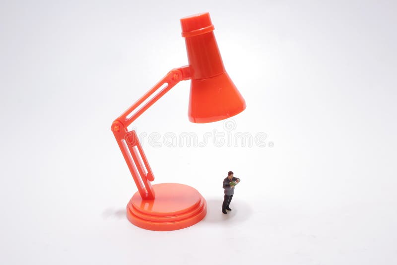 A Mini Figure is Reading a Book with Lamp Stock Photo - Image of ...