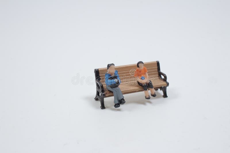 A Mini Figure Sit on the Park Bench Stock Image - Image of brown, chair ...