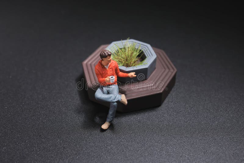 A Mini of Figure Sit on the Park Bench Stock Photo - Image of sitting ...
